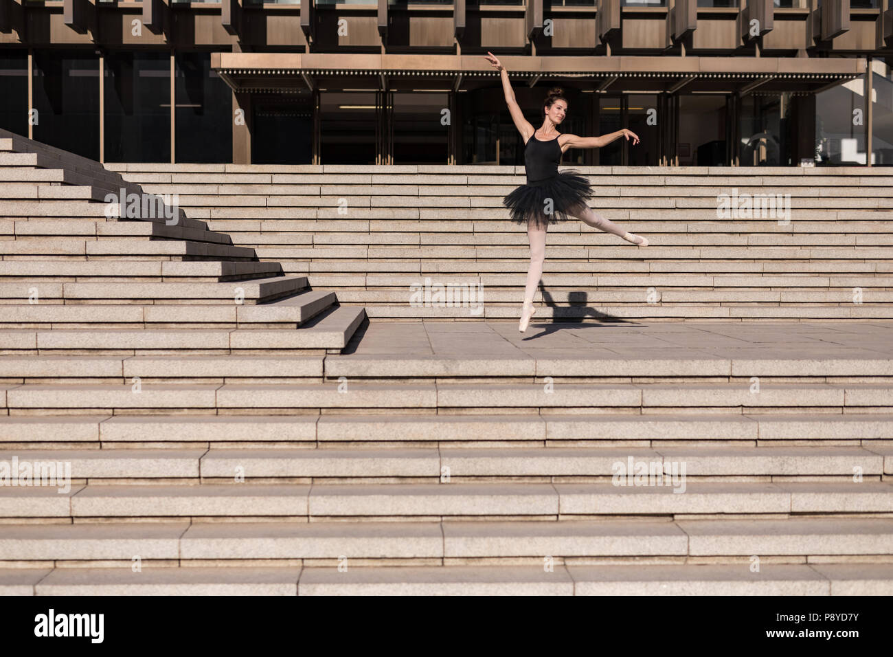 Woman standing on steps hi-res stock photography and images - Alamy