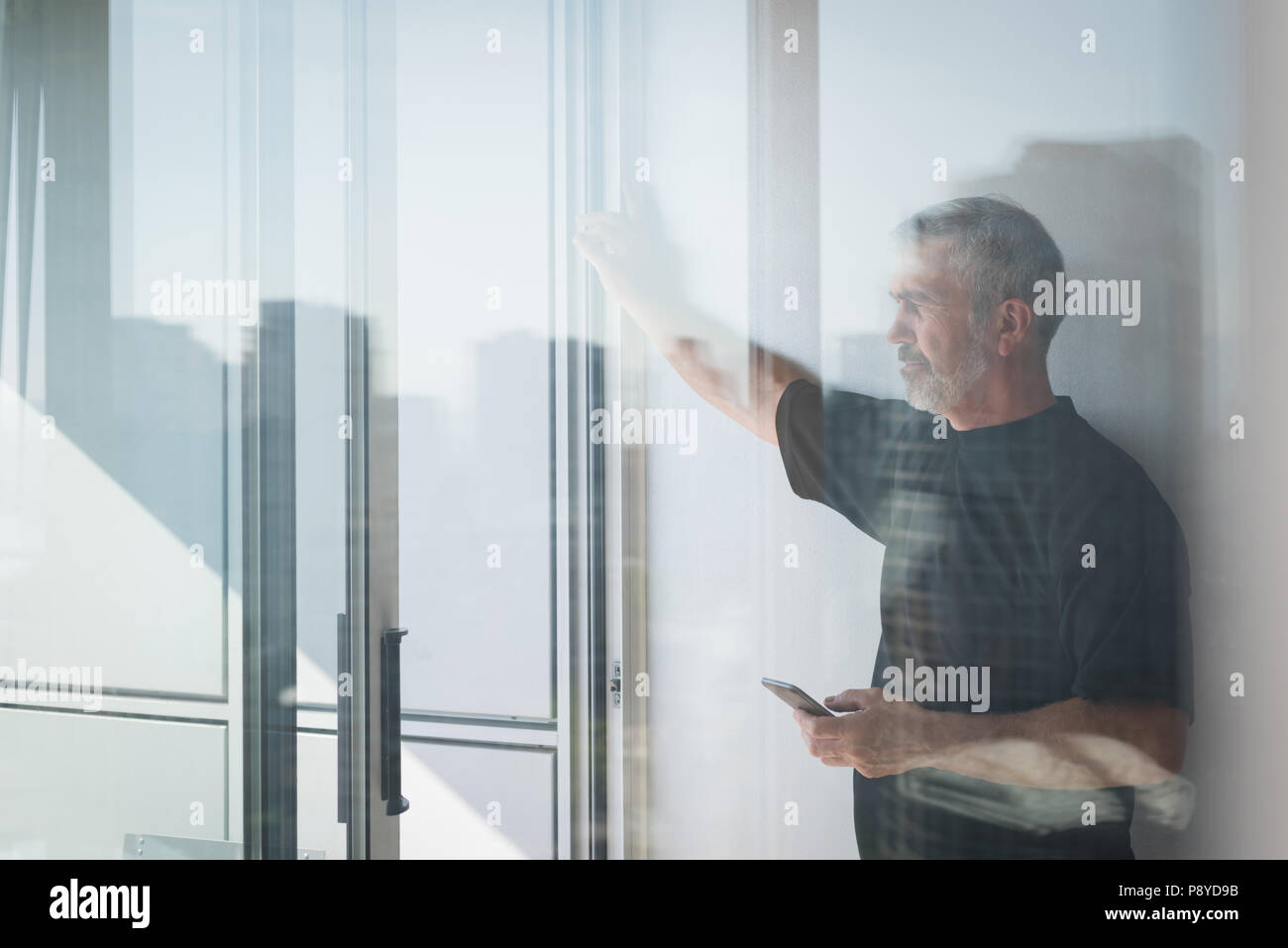 Man looking through the window hi-res stock photography and images - Alamy