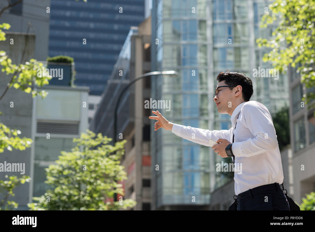 Man hailing a cab on the street Stock Photo - Alamy