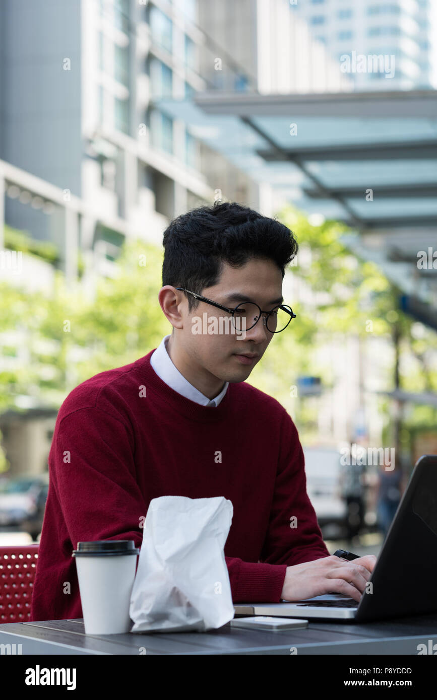 Young man sitting at outdoor cafe hi-res stock photography and images ...