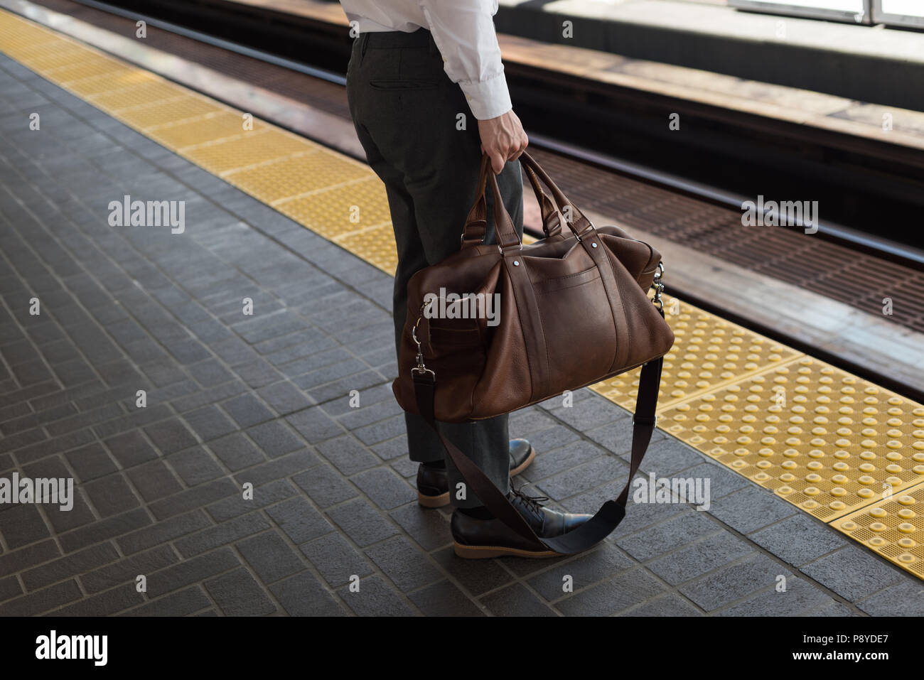 Man standing train station hi-res stock photography and images - Alamy