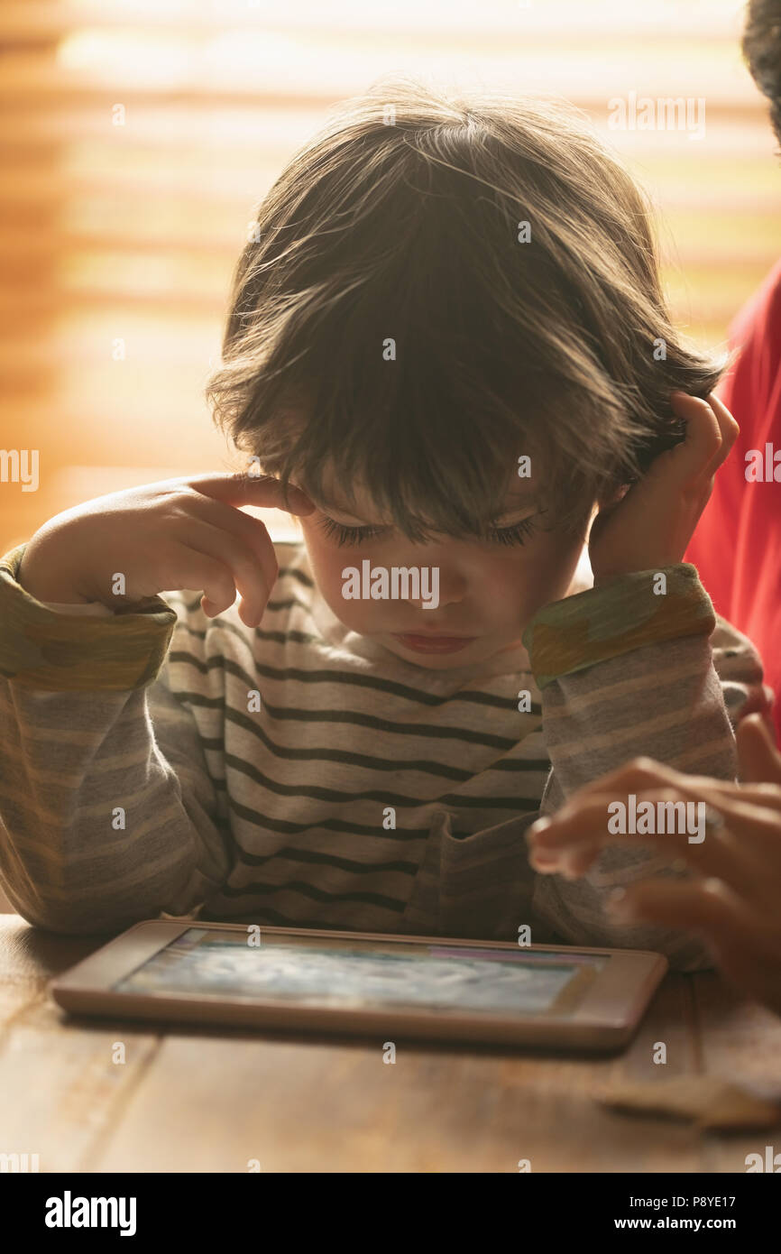 Boy looking at the tablet Stock Photo - Alamy