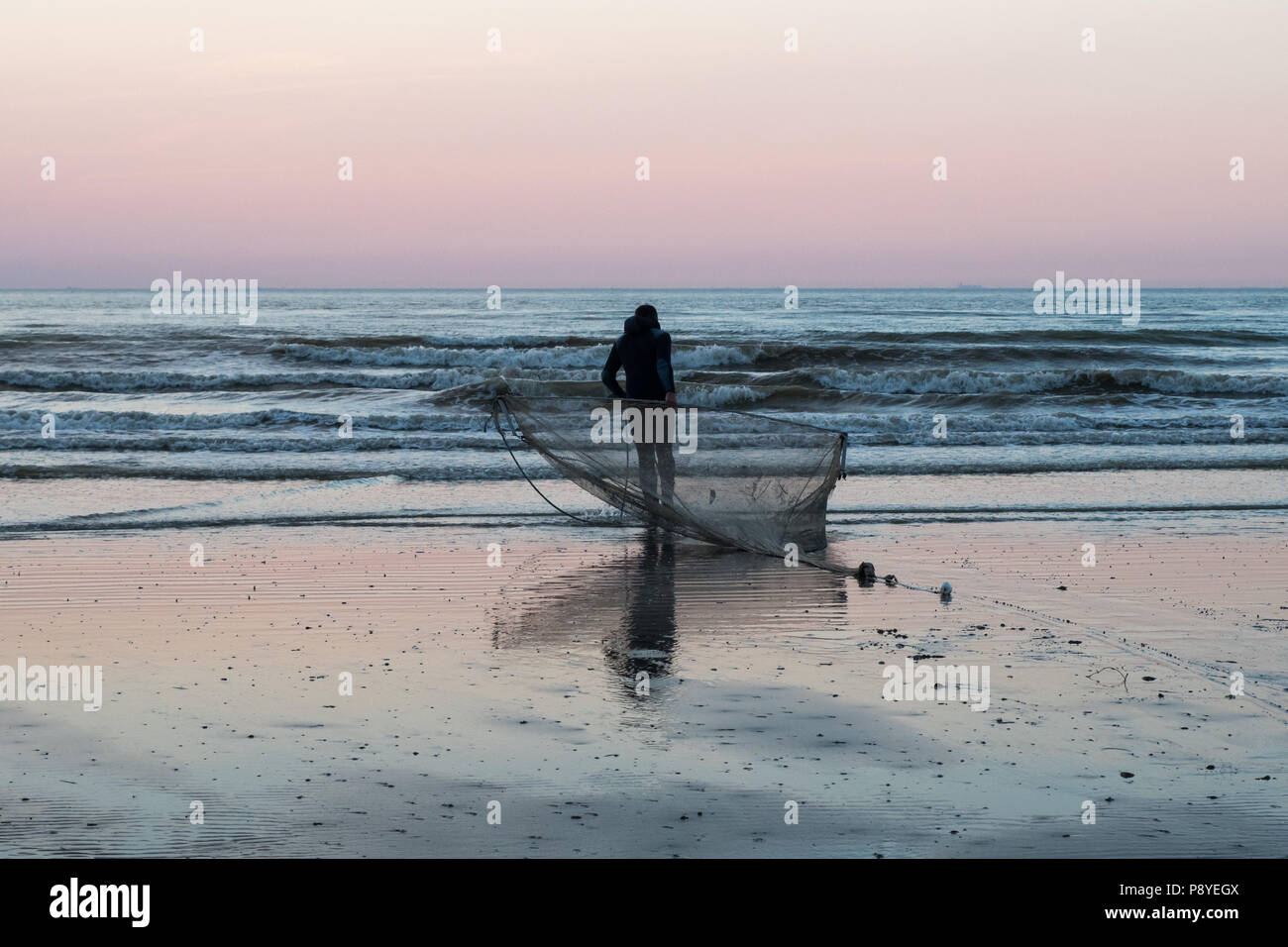 Sunset with fishermen (shrimp Stock Photo - Alamy