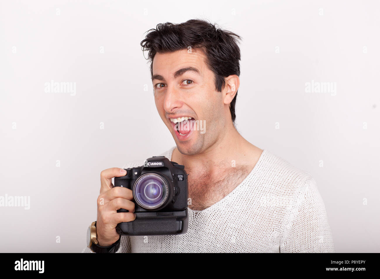 Male photographer smiling with a camera in his hand, happy photographer ...