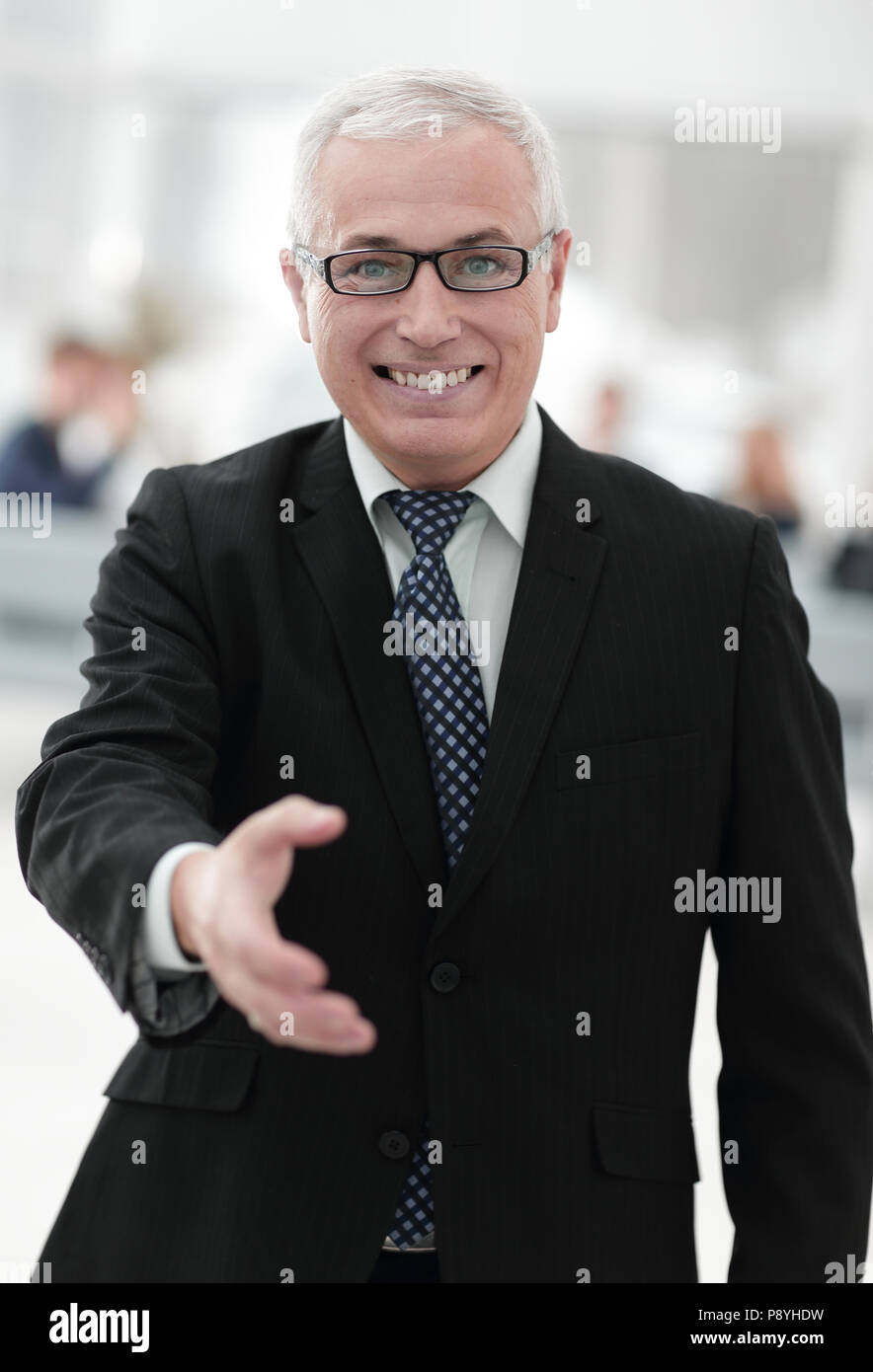 closeup of a senior businessman offering his hand for greeting Stock ...