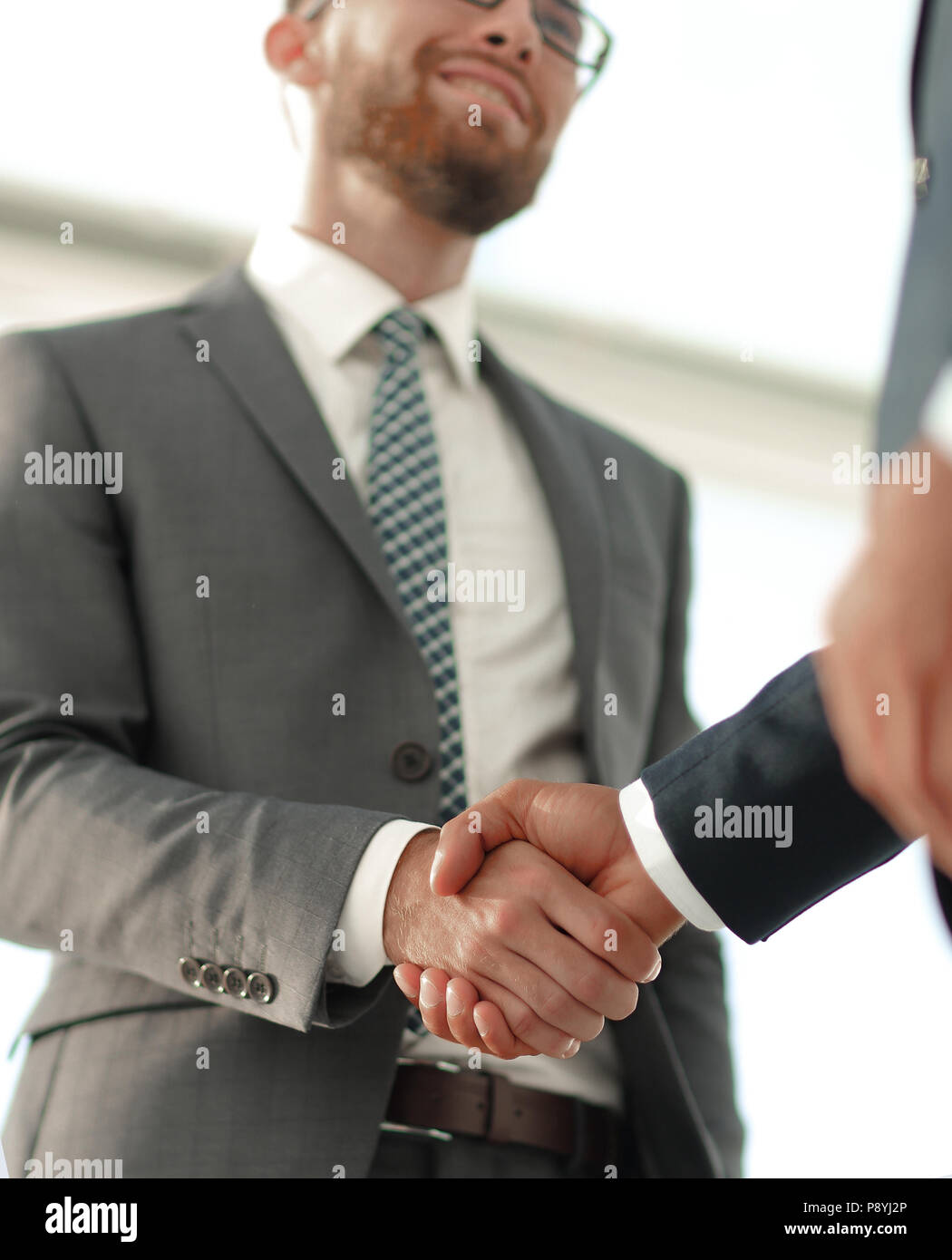 Friendly smiling businessmen handshaking. Business concept photo Stock ...