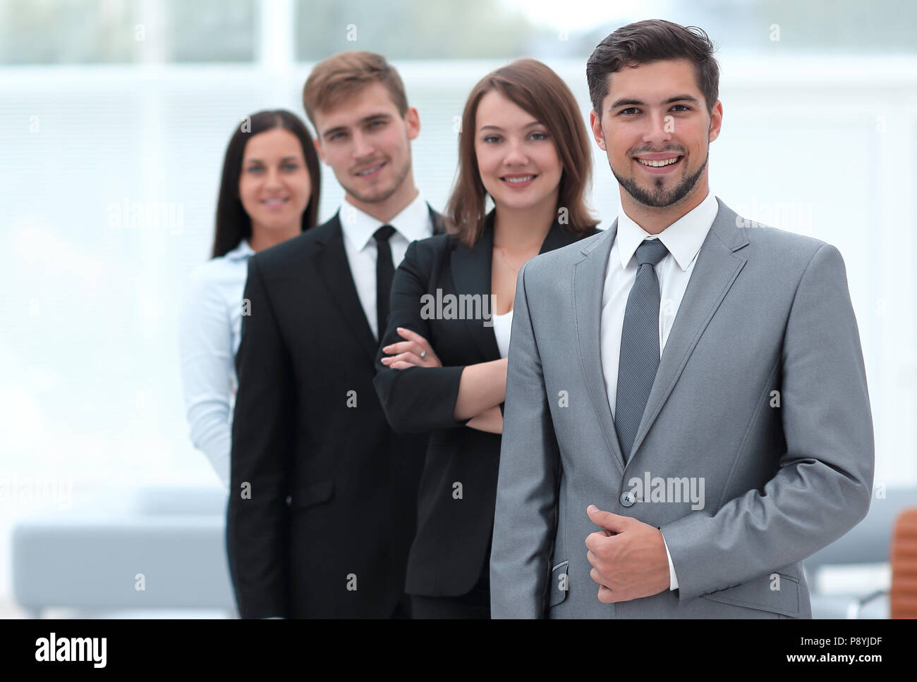 leader and the business team standing one behind the other Stock Photo ...