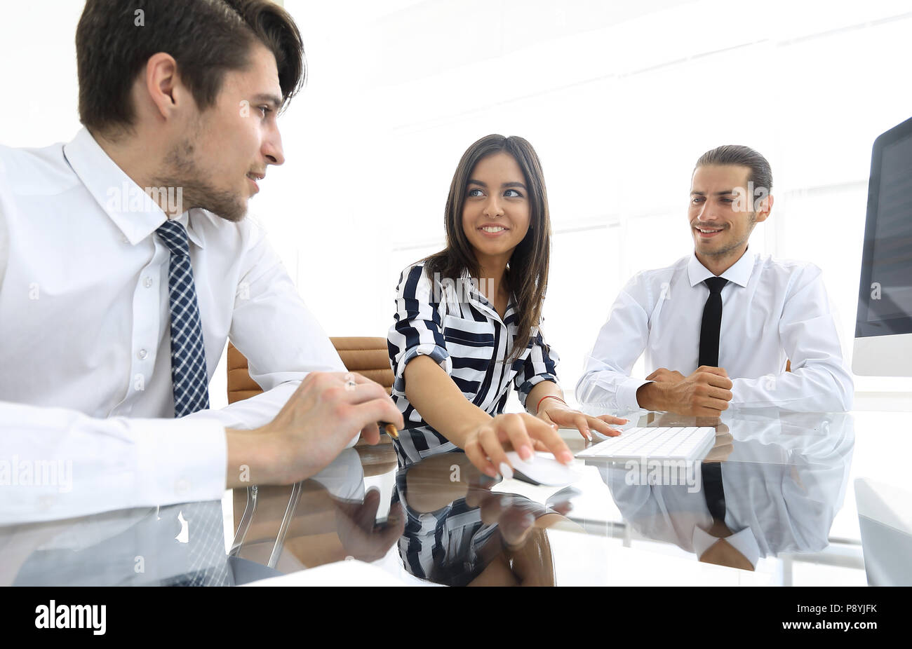 business team sitting at Desk Stock Photo - Alamy