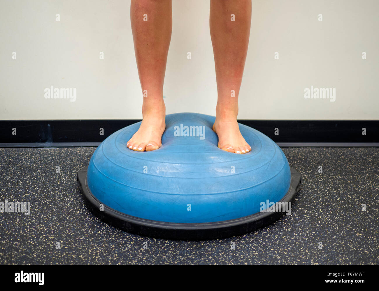 Athlete doing strengthening and balance exercises on a bosu ball Stock ...