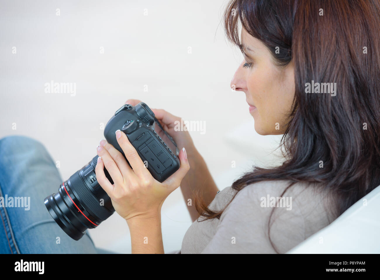 female photographer checking pictures Stock Photo - Alamy