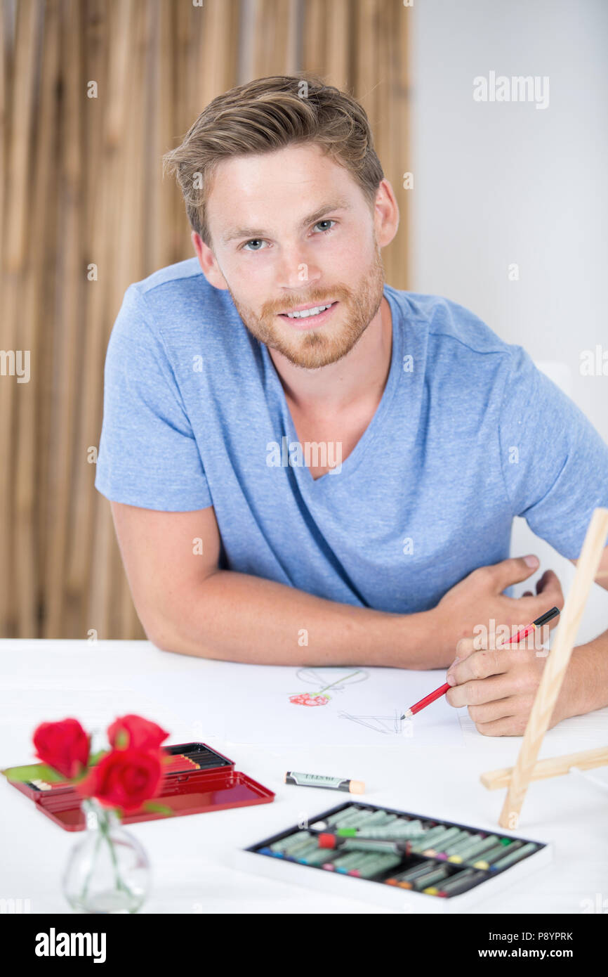 young man drawing pictures in studio Stock Photo - Alamy