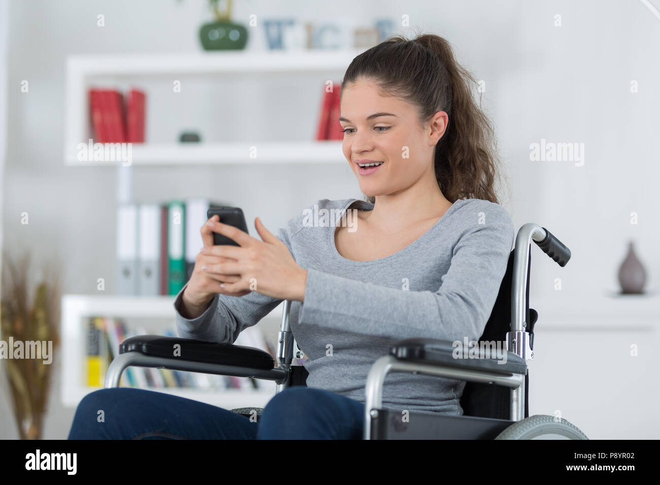 Disabled girl delighted to read message on cellphone Stock Photo - Alamy