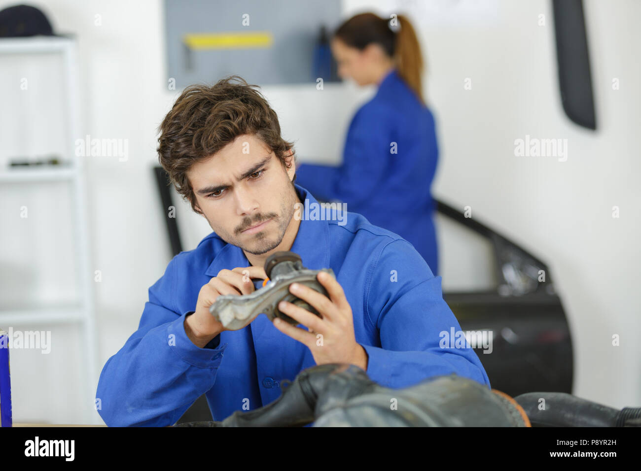 mechanic man repairing car part Stock Photo - Alamy