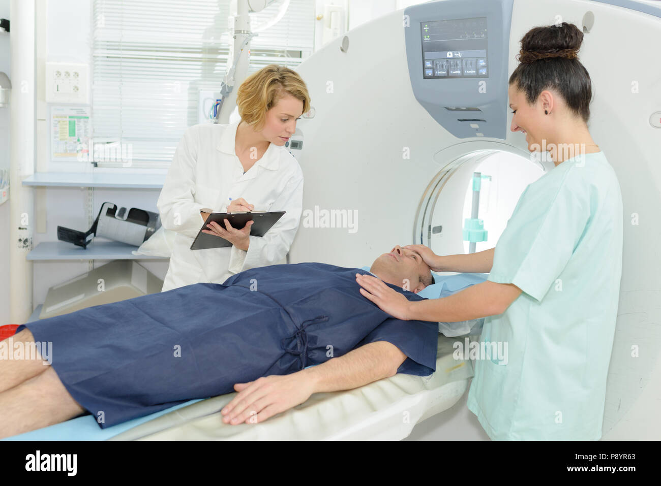 nurse adjusting patients face before mri scan Stock Photo - Alamy
