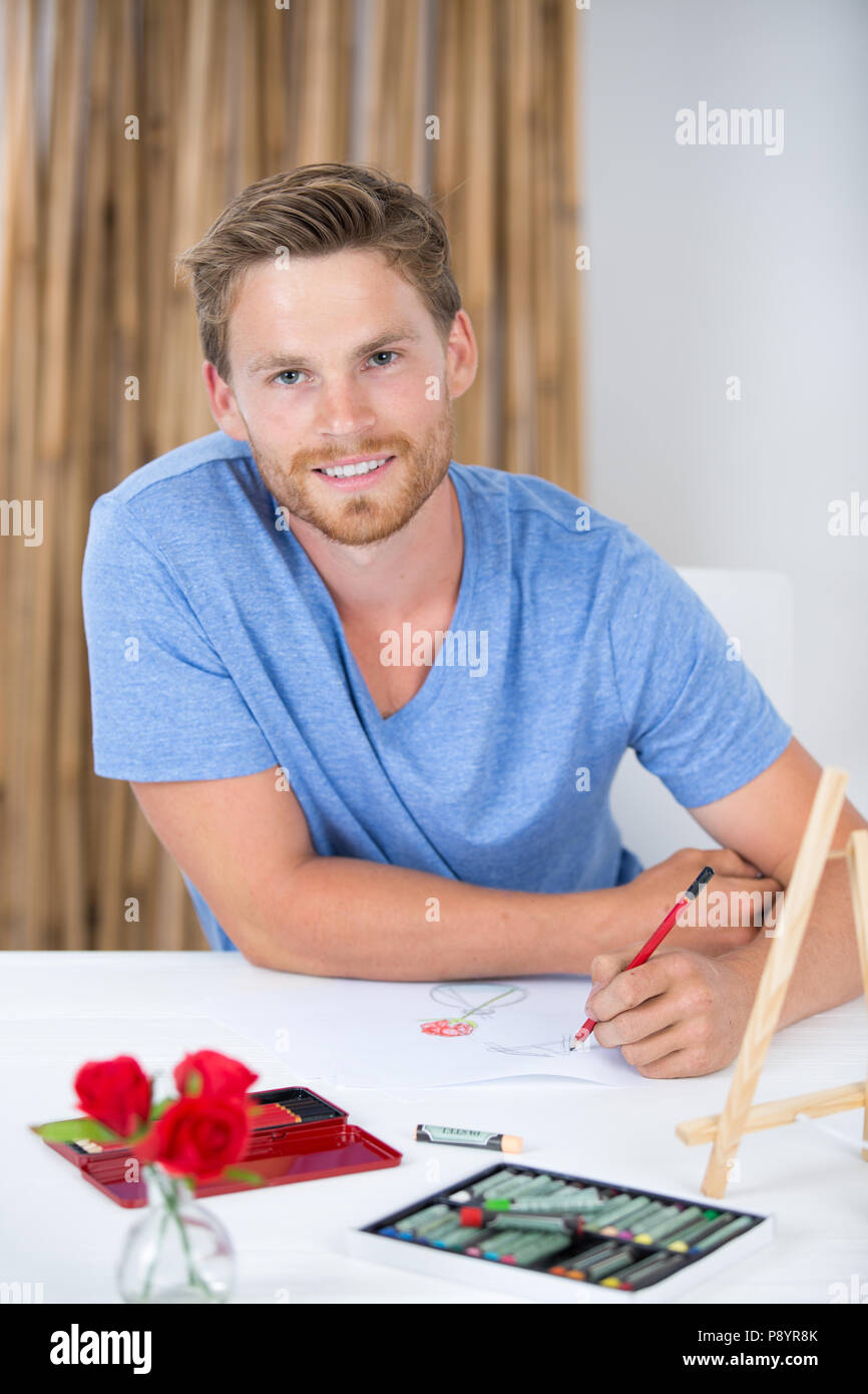 young man drawing pictures in studio Stock Photo - Alamy