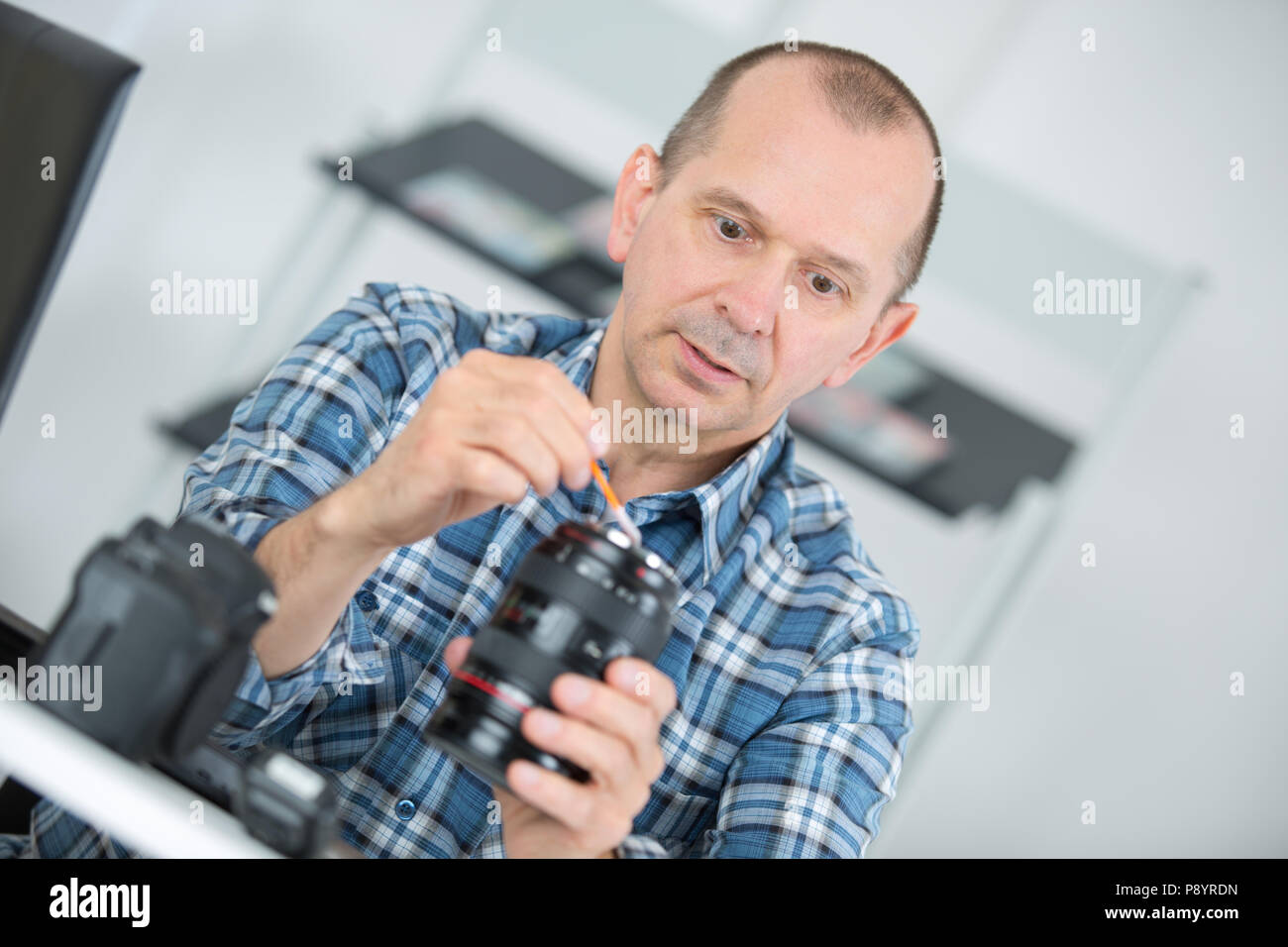 Mature man cleaning lens hi-res stock photography and images - Alamy