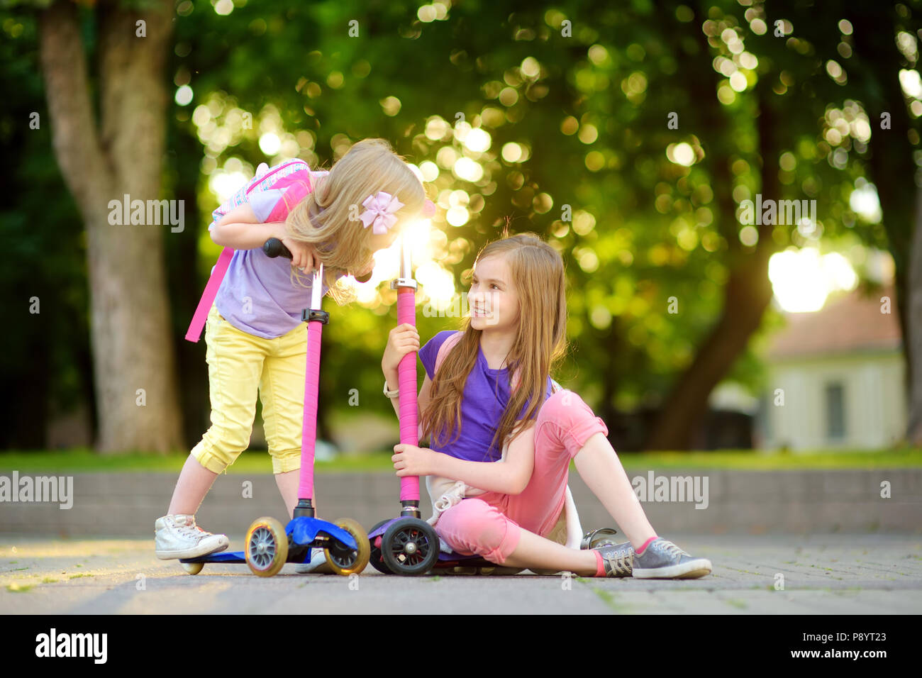 Children riding their scooters hi-res stock photography and images - Alamy