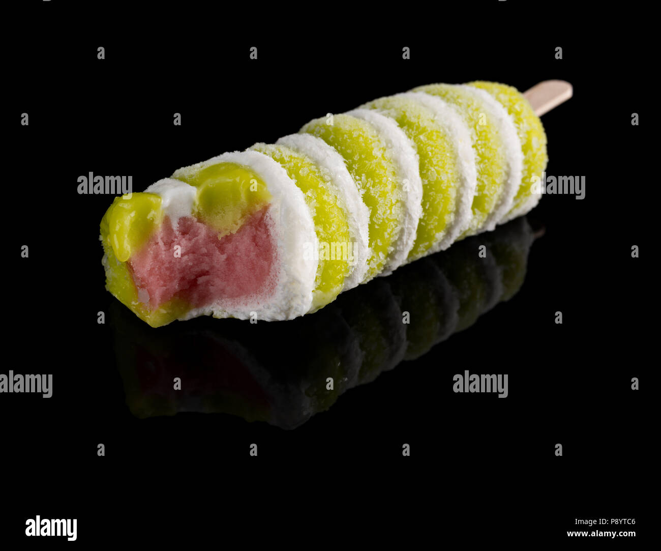 multi color popsicle with bites on a black background Stock Photo - Alamy