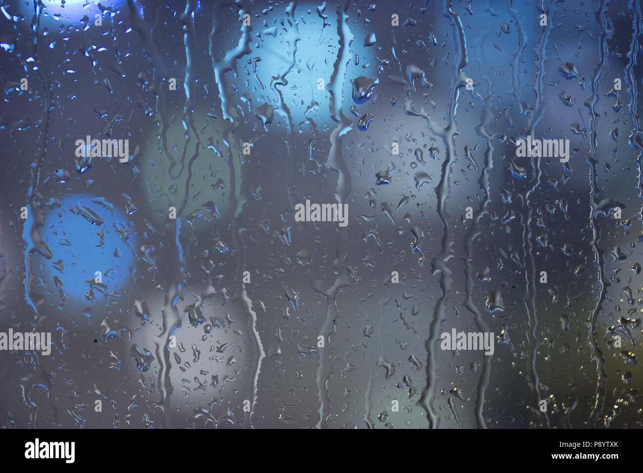 Drops of rain on window, night. blurred light Stock Photo - Alamy