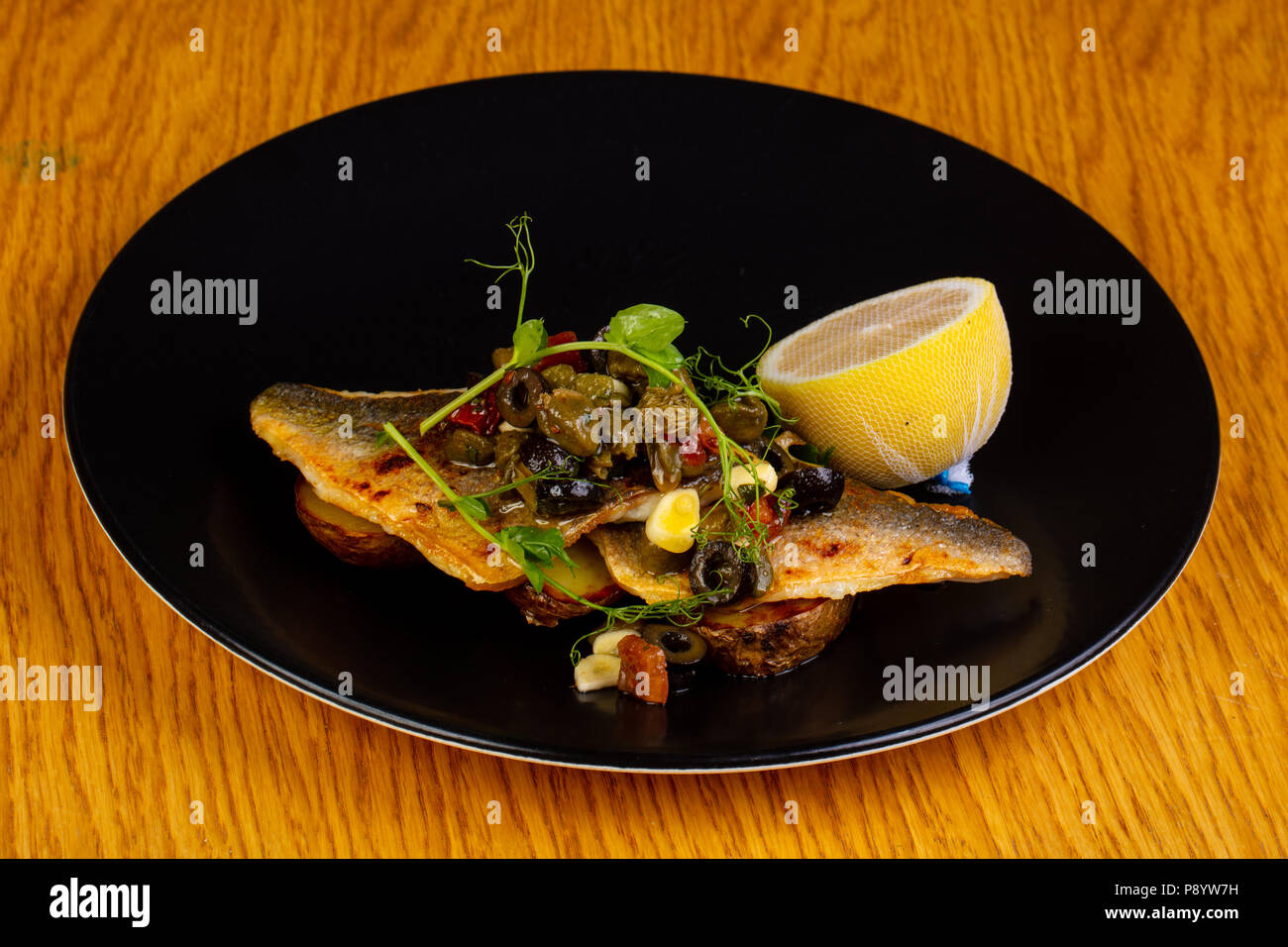 Dorada fillet with herbs and lemon Stock Photo - Alamy