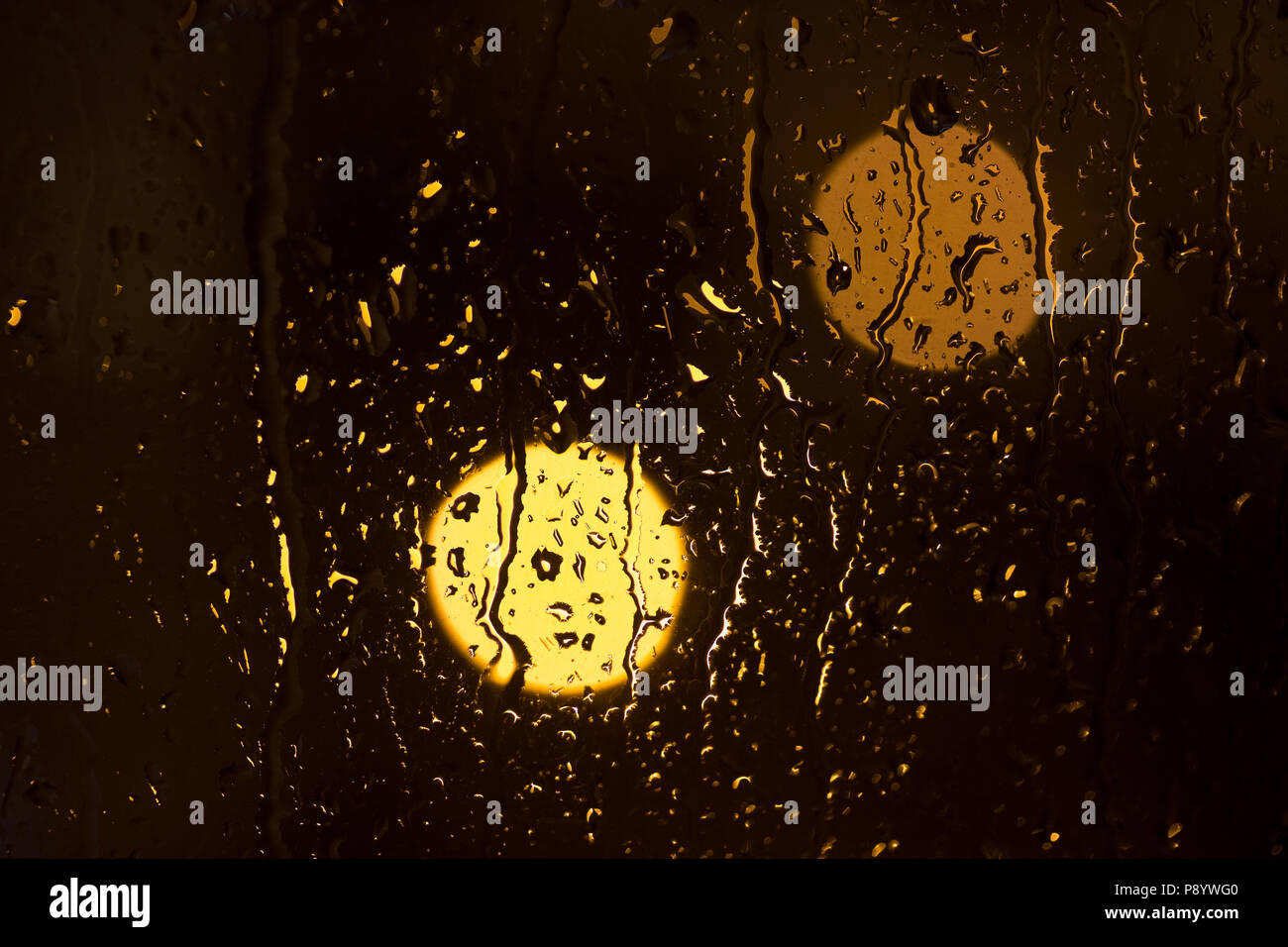 Drops of rain on window, night. blurred light Stock Photo - Alamy
