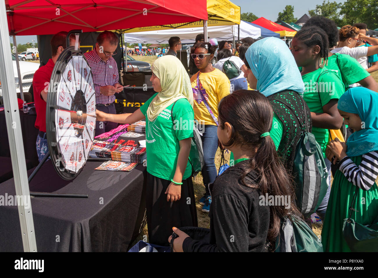Detroit, Michigan - Children spin a wheel to win trinkets at the ...