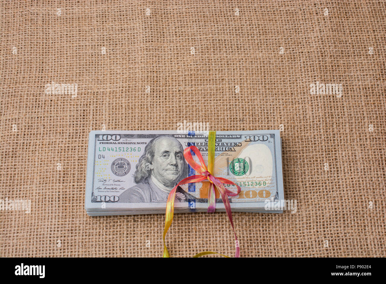 Banknote bundle of US dollar tied with colorful a ribbon Stock Photo ...