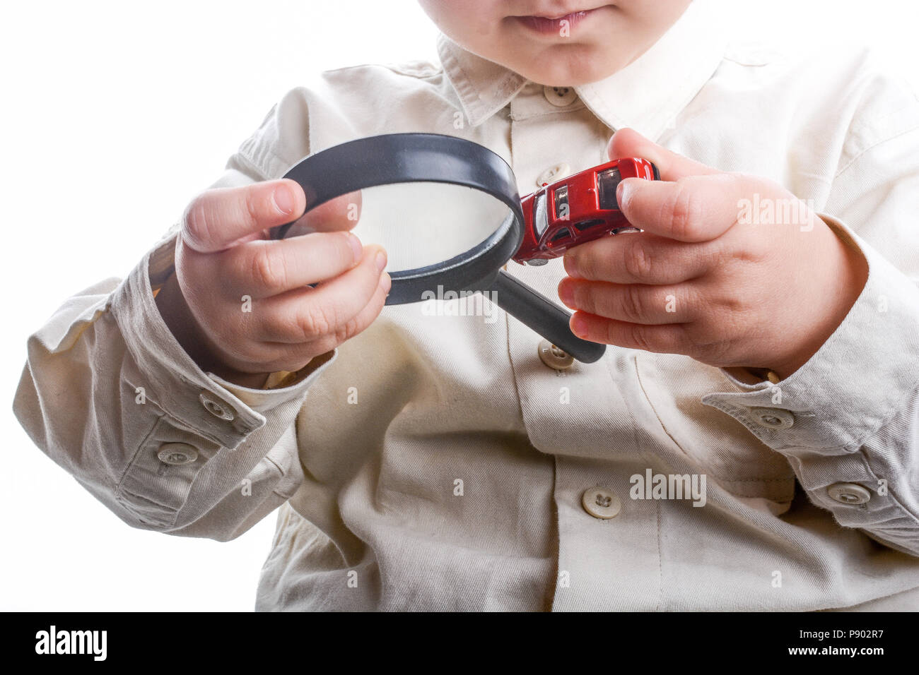 Baby holding a magnifying glass in hand on a white background Stock ...