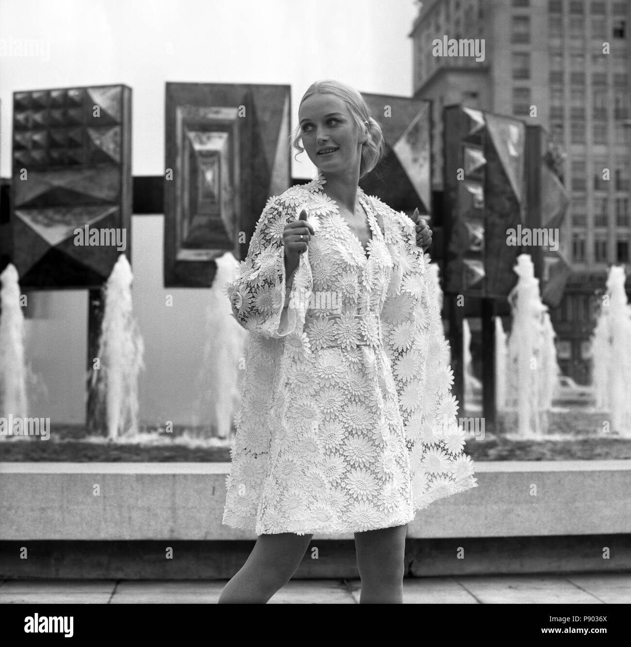 Berlin, GDR, young woman wearing the latest summer fashion in front of ...