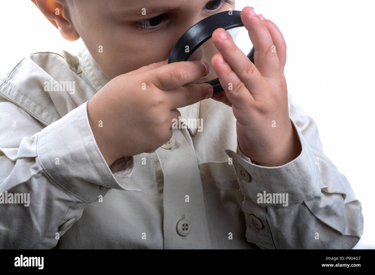 Baby holding a magnifying glass in hand on a white background Stock ...