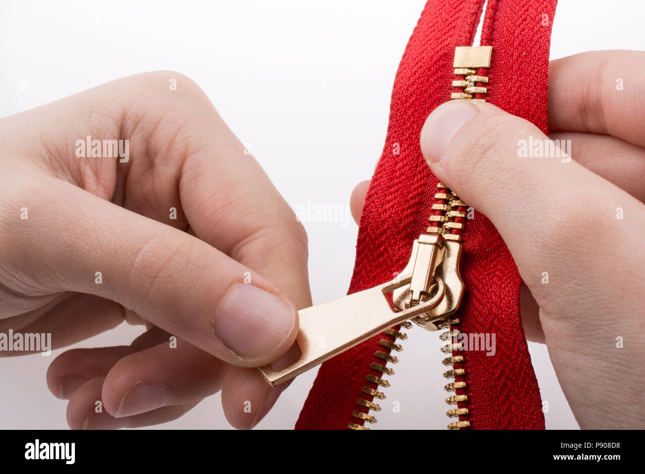 Hand holding color zipper on a white background Stock Photo - Alamy