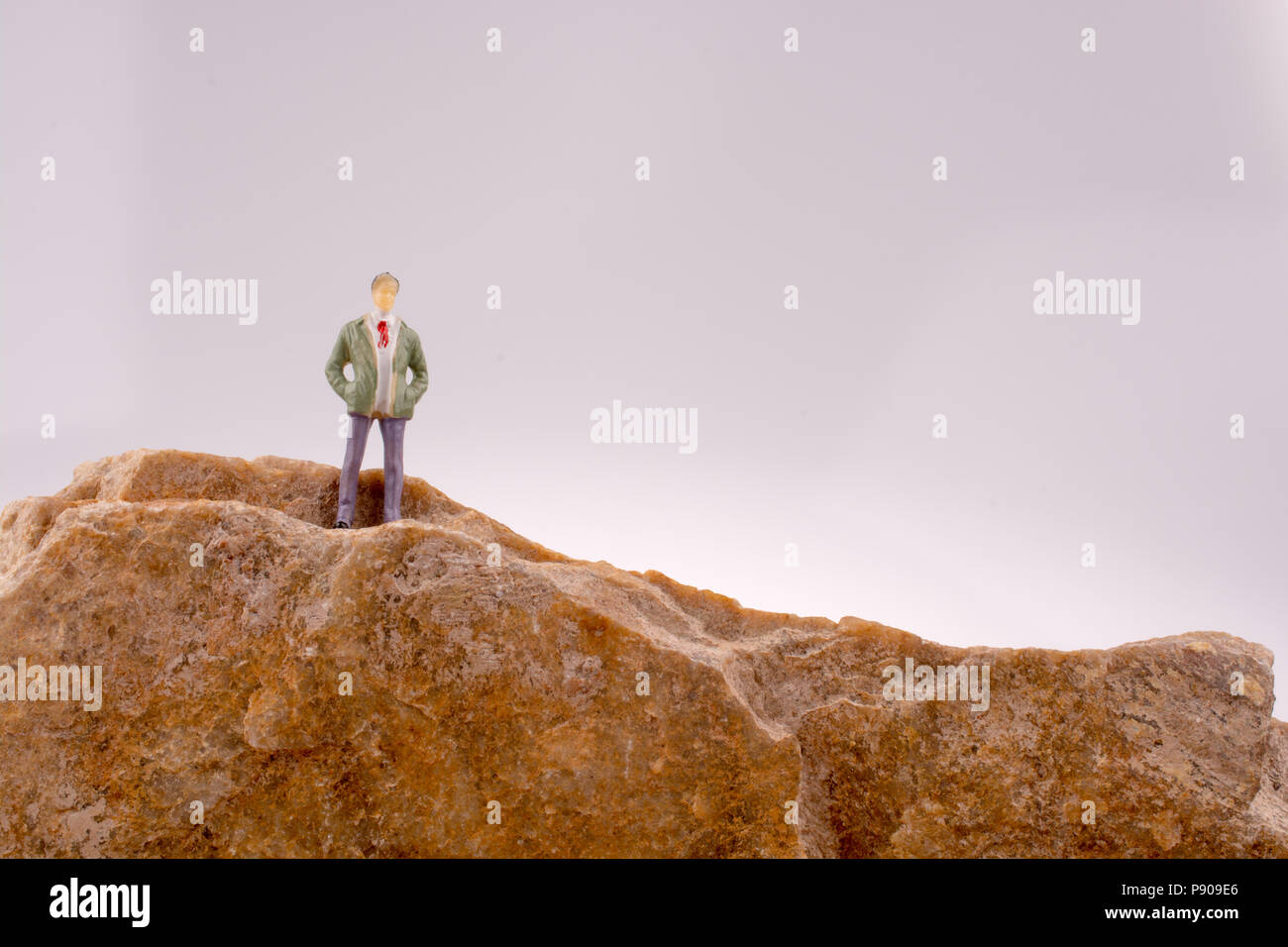 Human figure on rock on a white background Stock Photo - Alamy