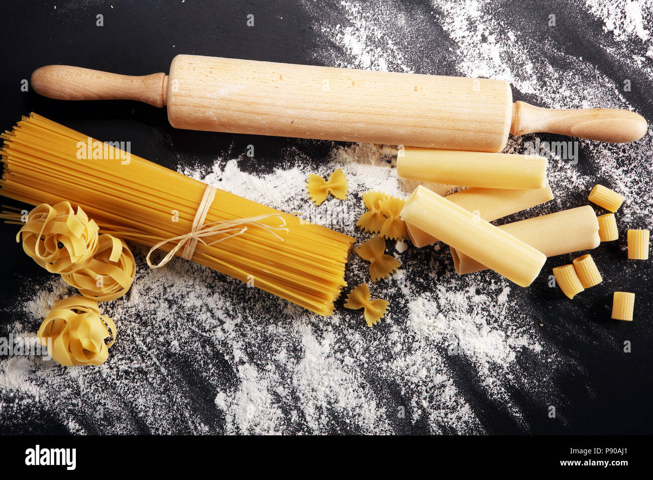 Various mix of pasta on rustic background. Making homemade pasta Stock ...