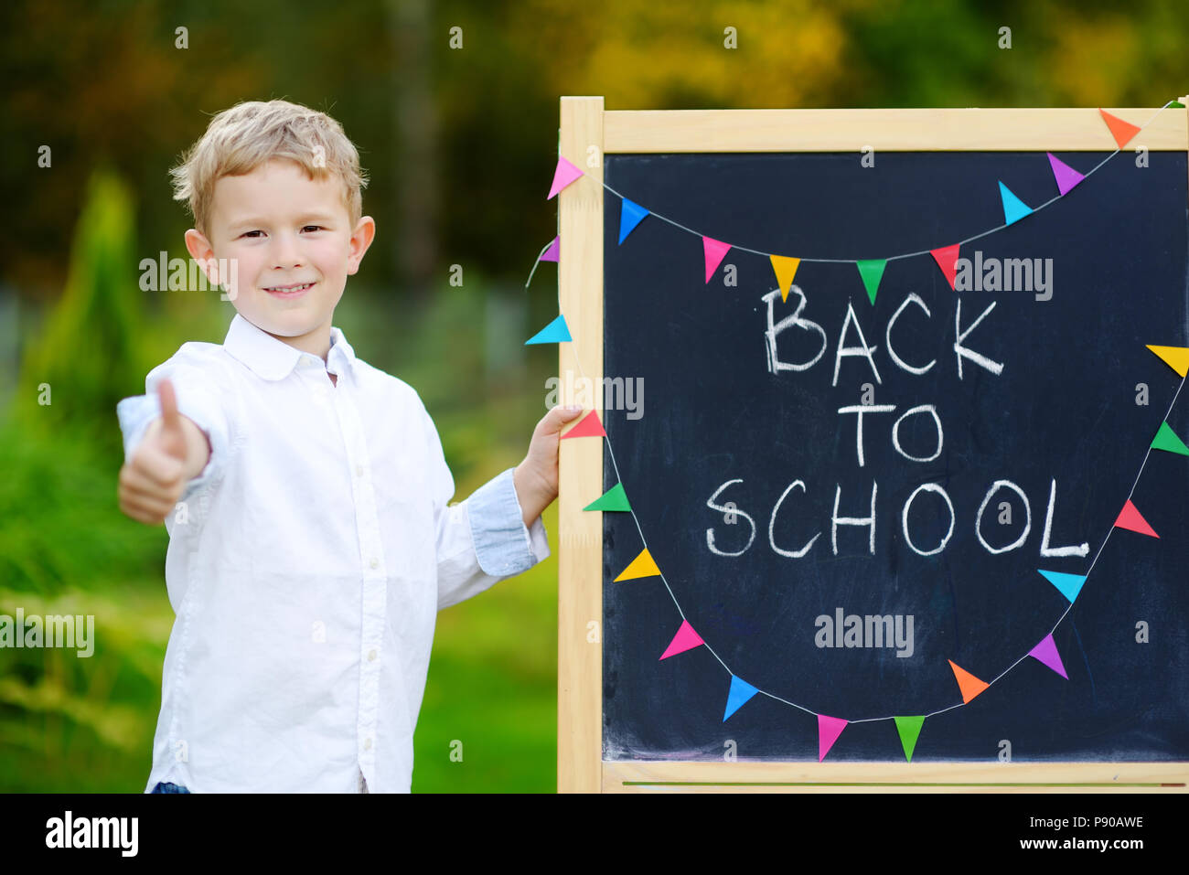 Adorable little boy feeling very exited about going back to school ...