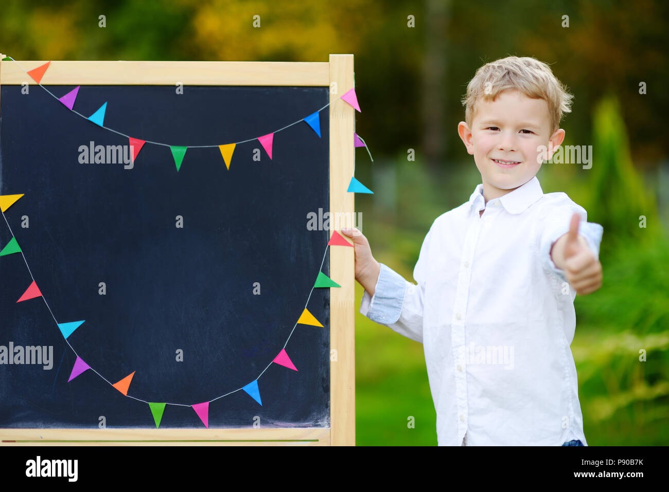 Adorable little boy feeling very exited about going back to school ...