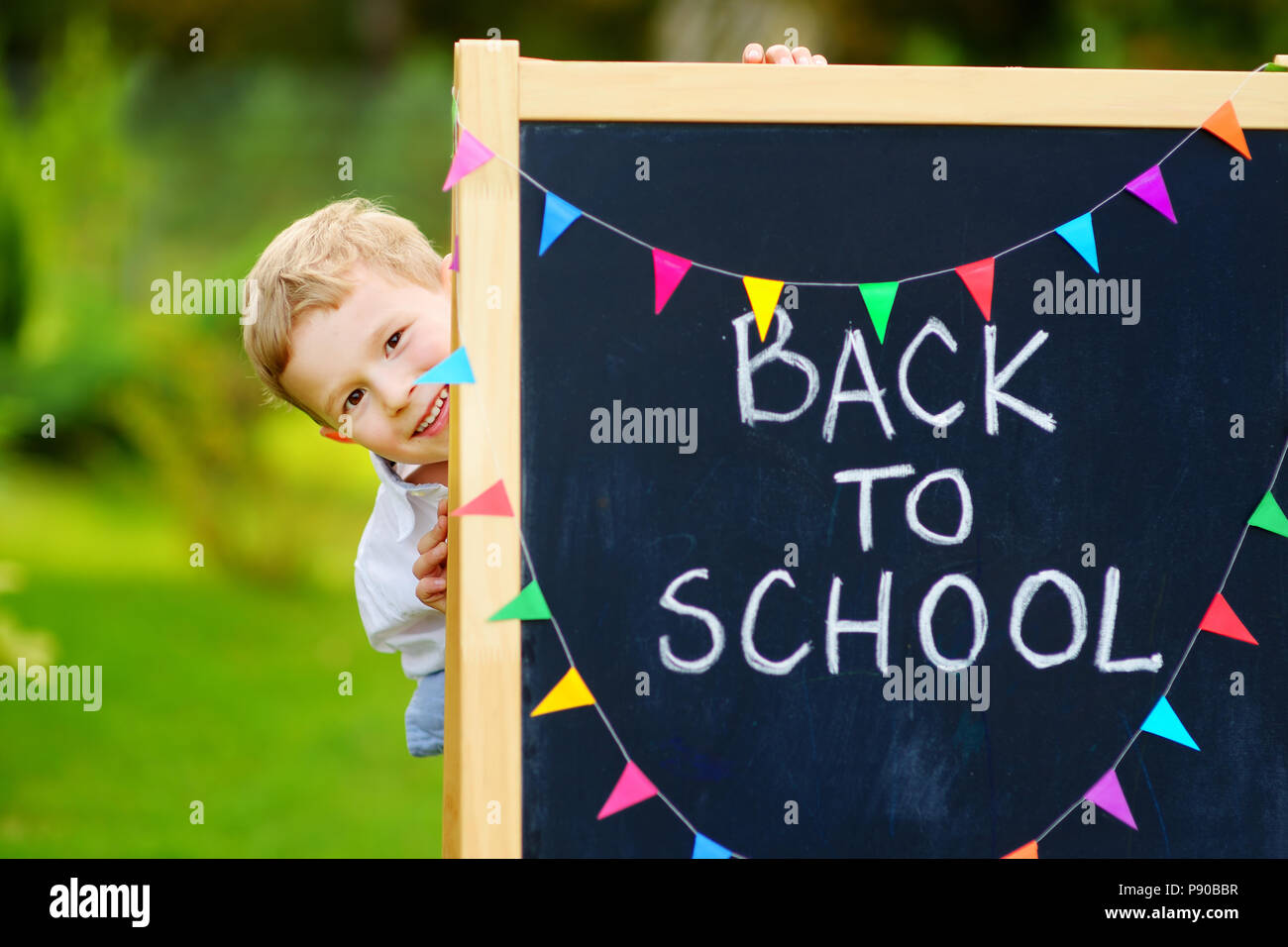 Adorable little boy feeling very exited about going back to school ...