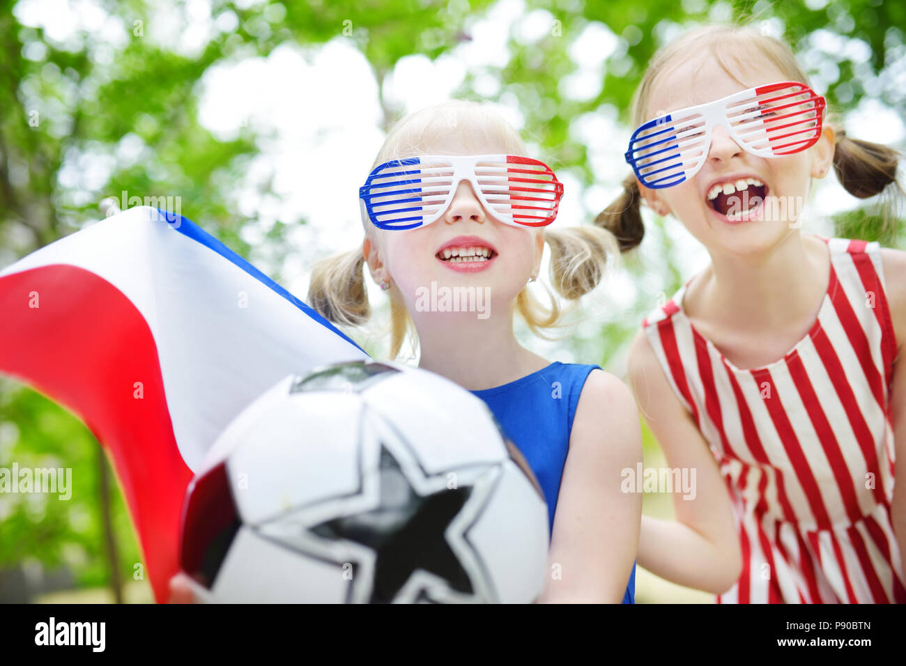 Two adorable little soccer fans cheering on summer day Stock Photo - Alamy