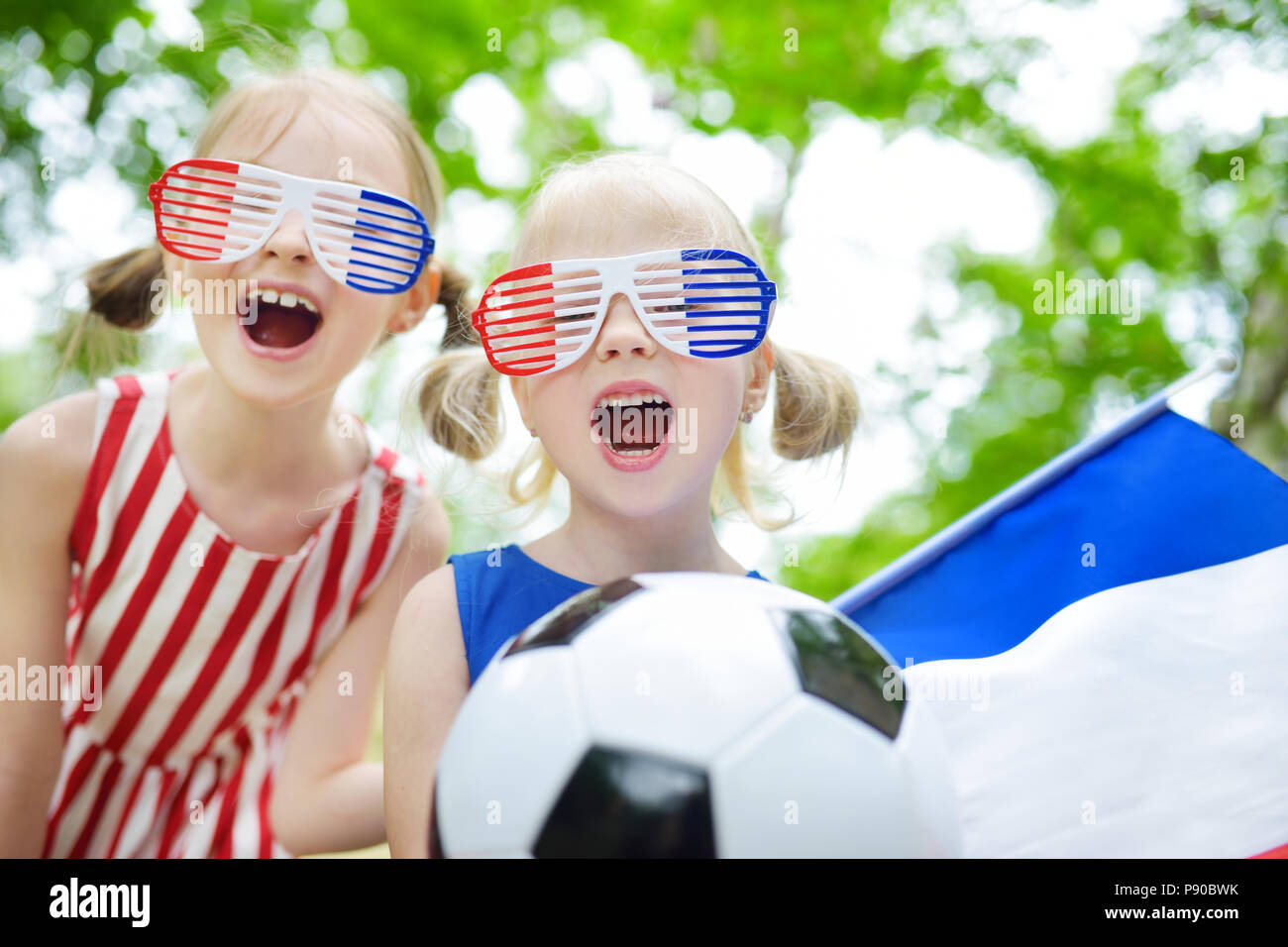 Two adorable little soccer fans cheering on summer day Stock Photo - Alamy