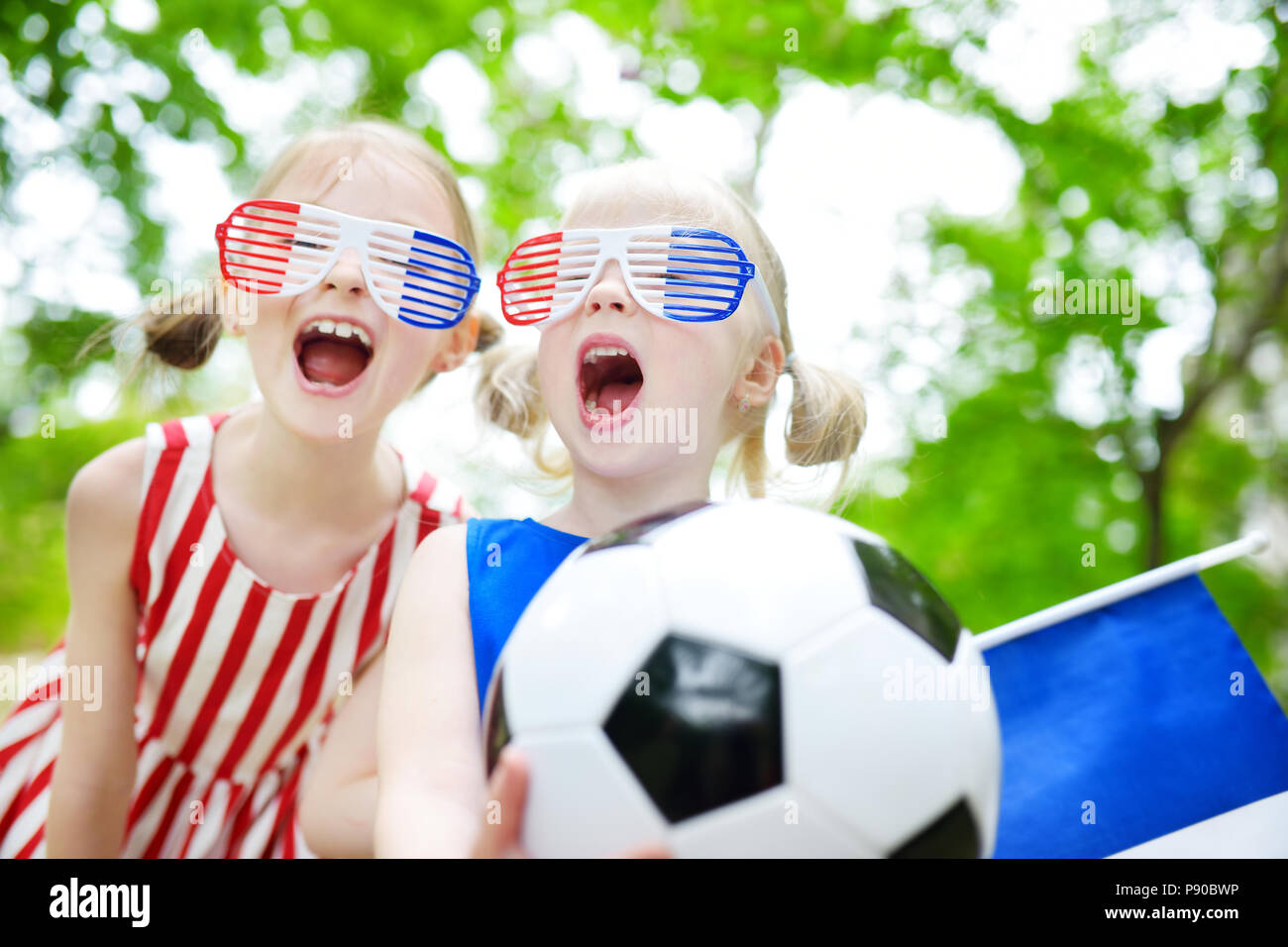 Two adorable little soccer fans cheering on summer day Stock Photo - Alamy