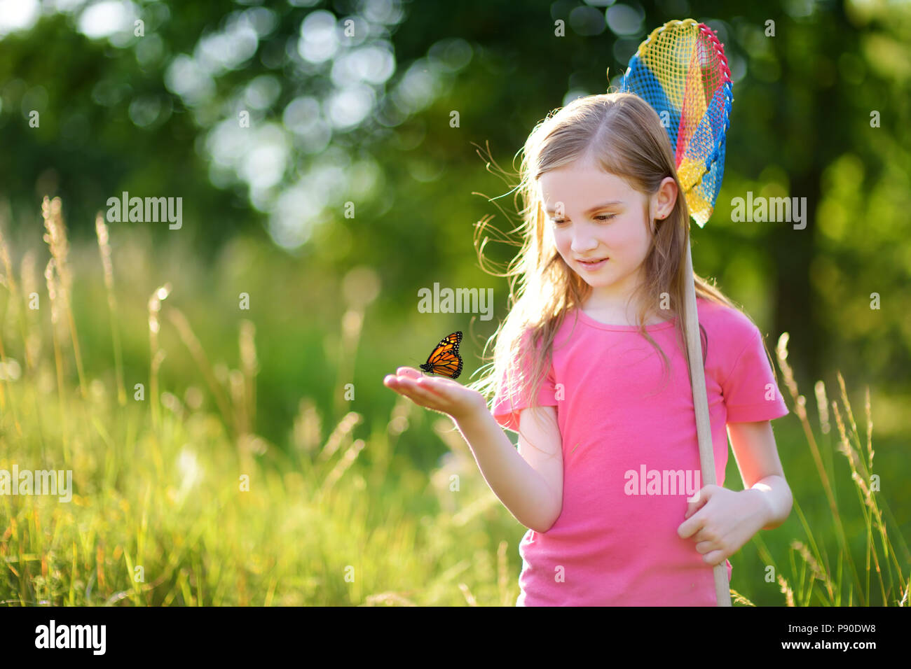 Cute little girl catching butterflies and bugs with her scoop-net on ...