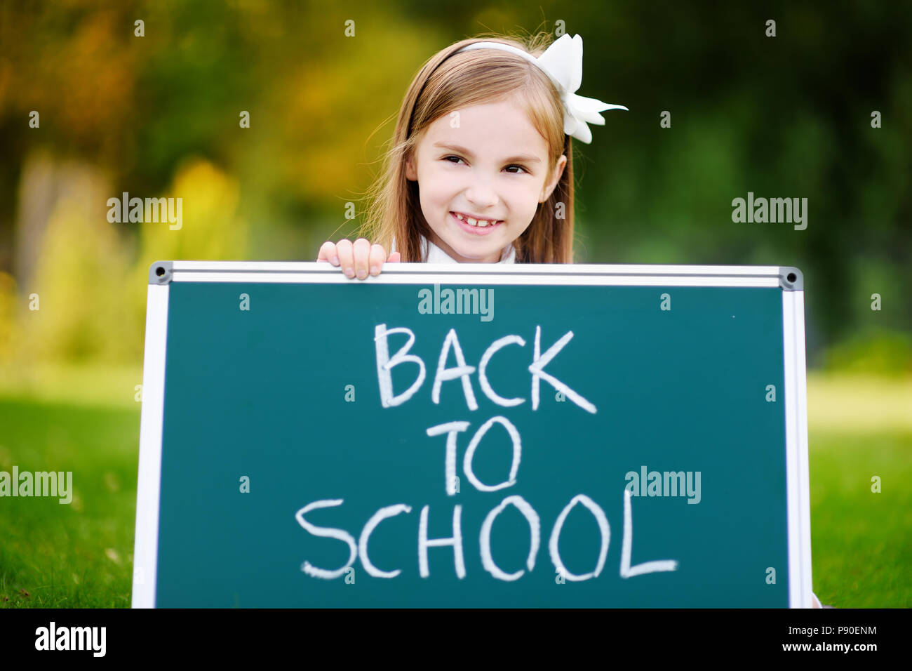 Adorable little girl feeling very excited about going back to school ...