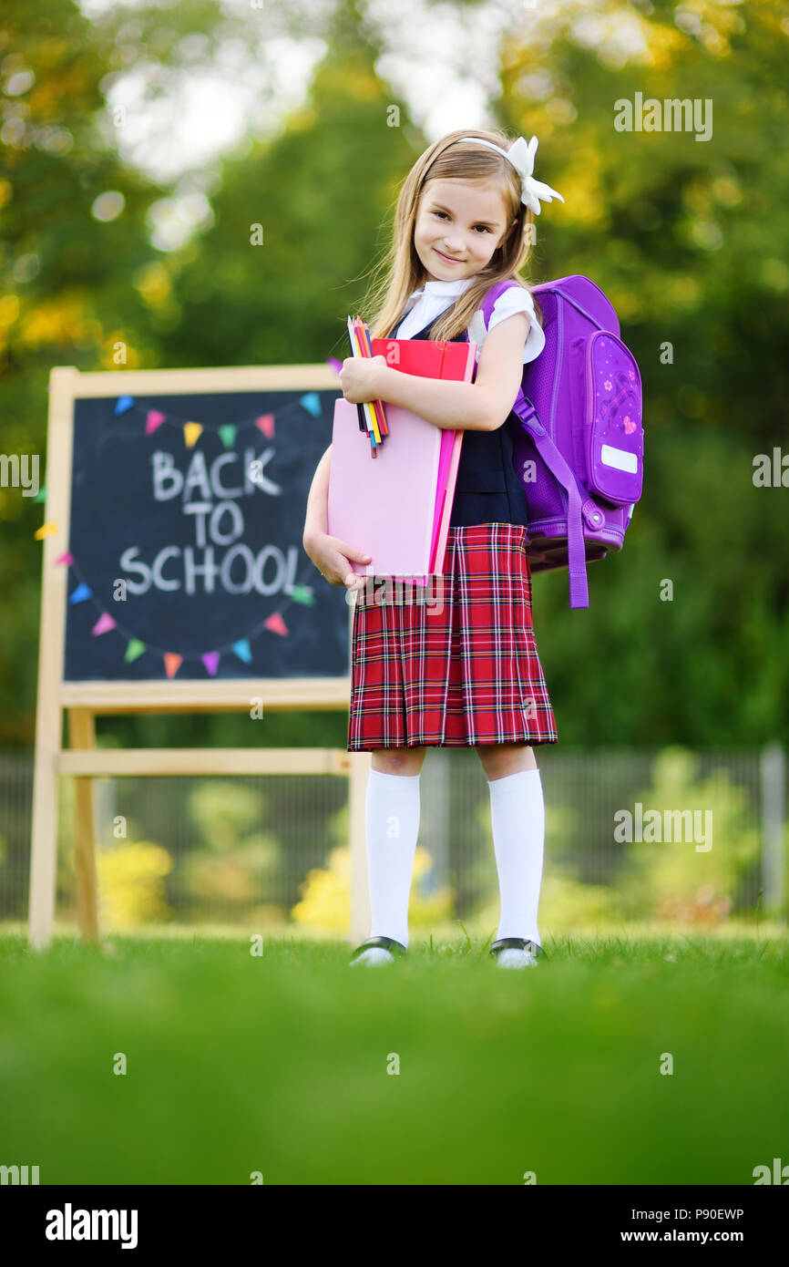 Adorable little girl feeling very excited about going back to school ...