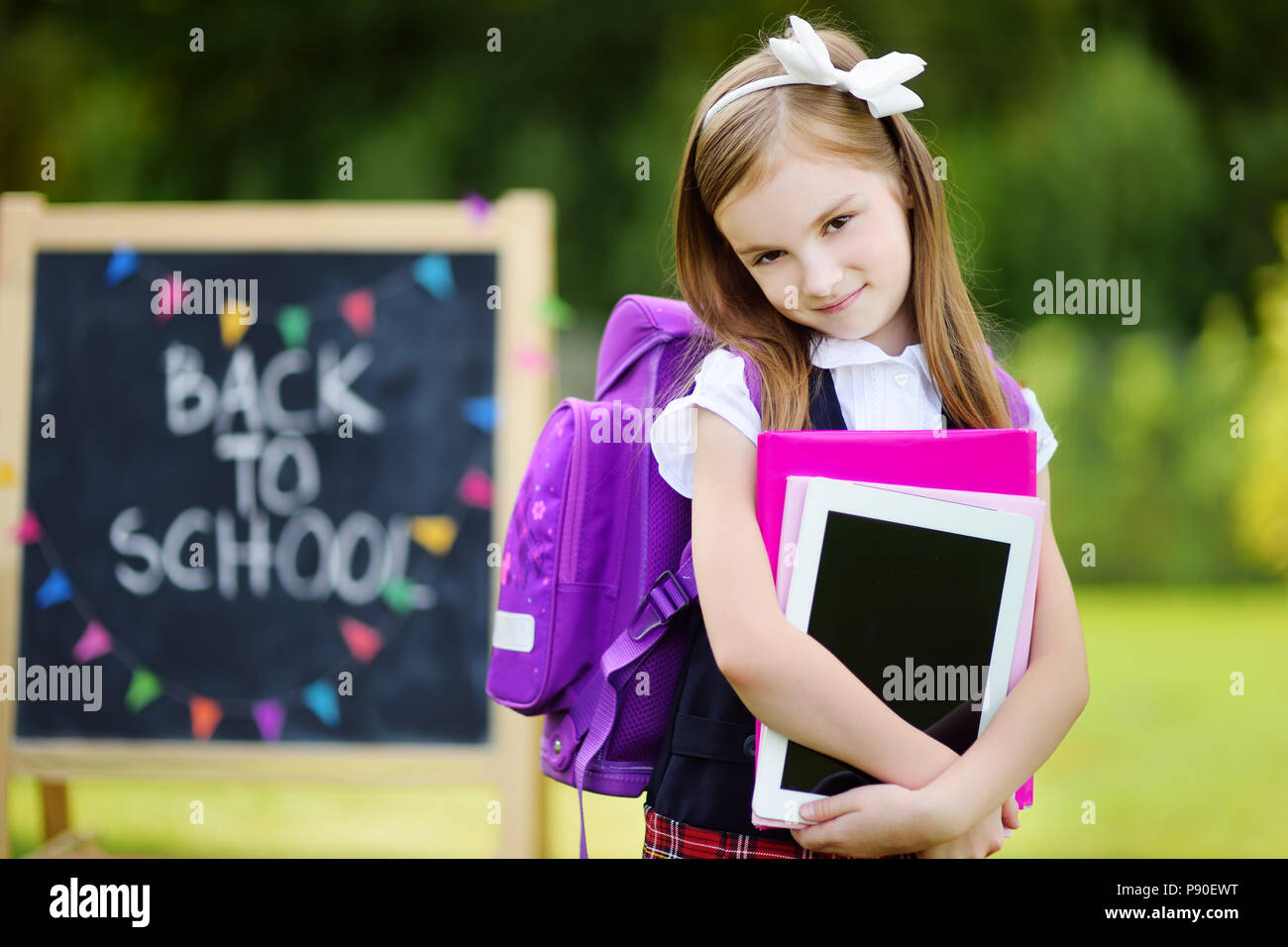 Adorable little girl feeling very excited about going back to school ...
