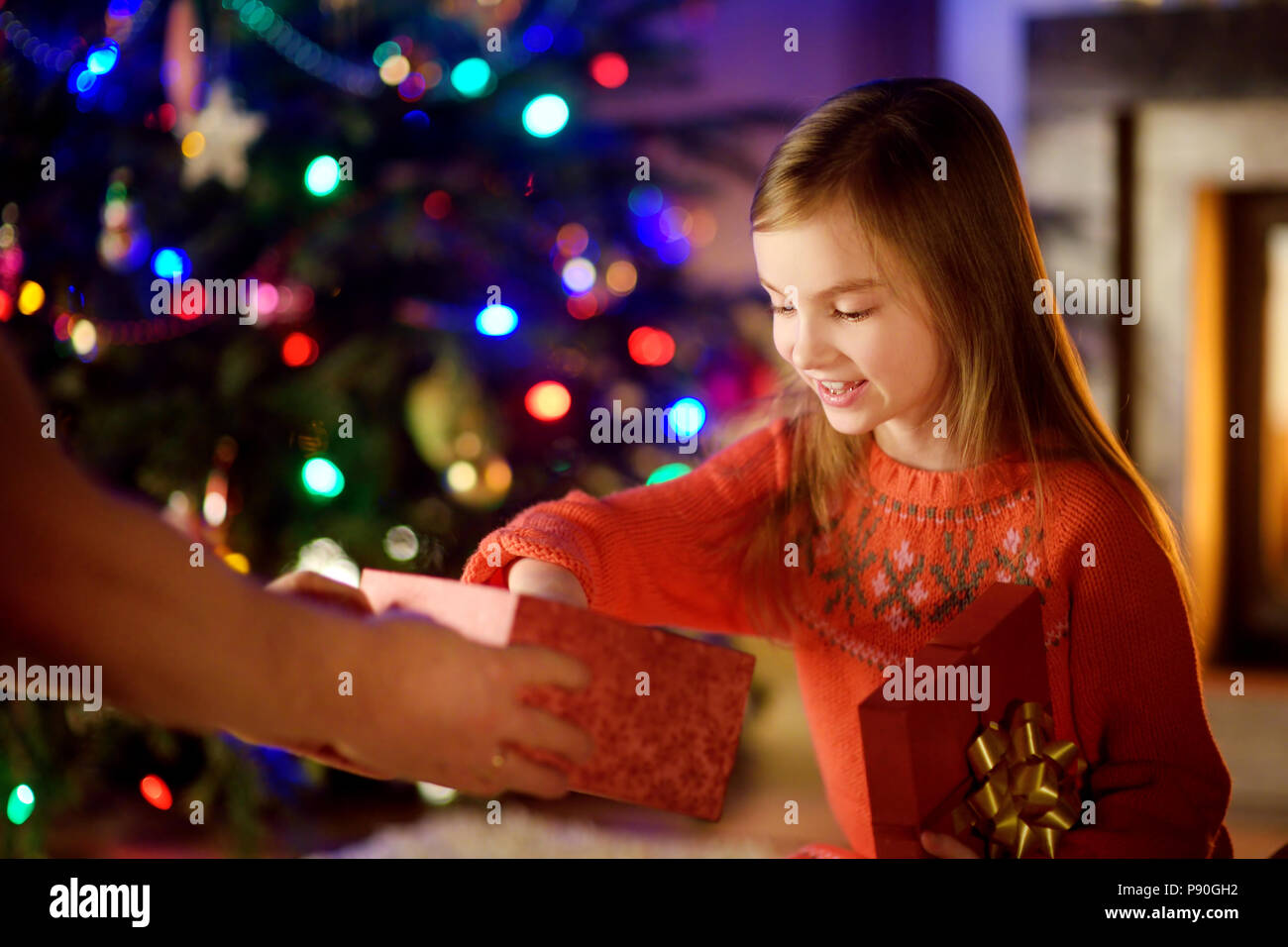 Child getting present christmas hi-res stock photography and images - Alamy