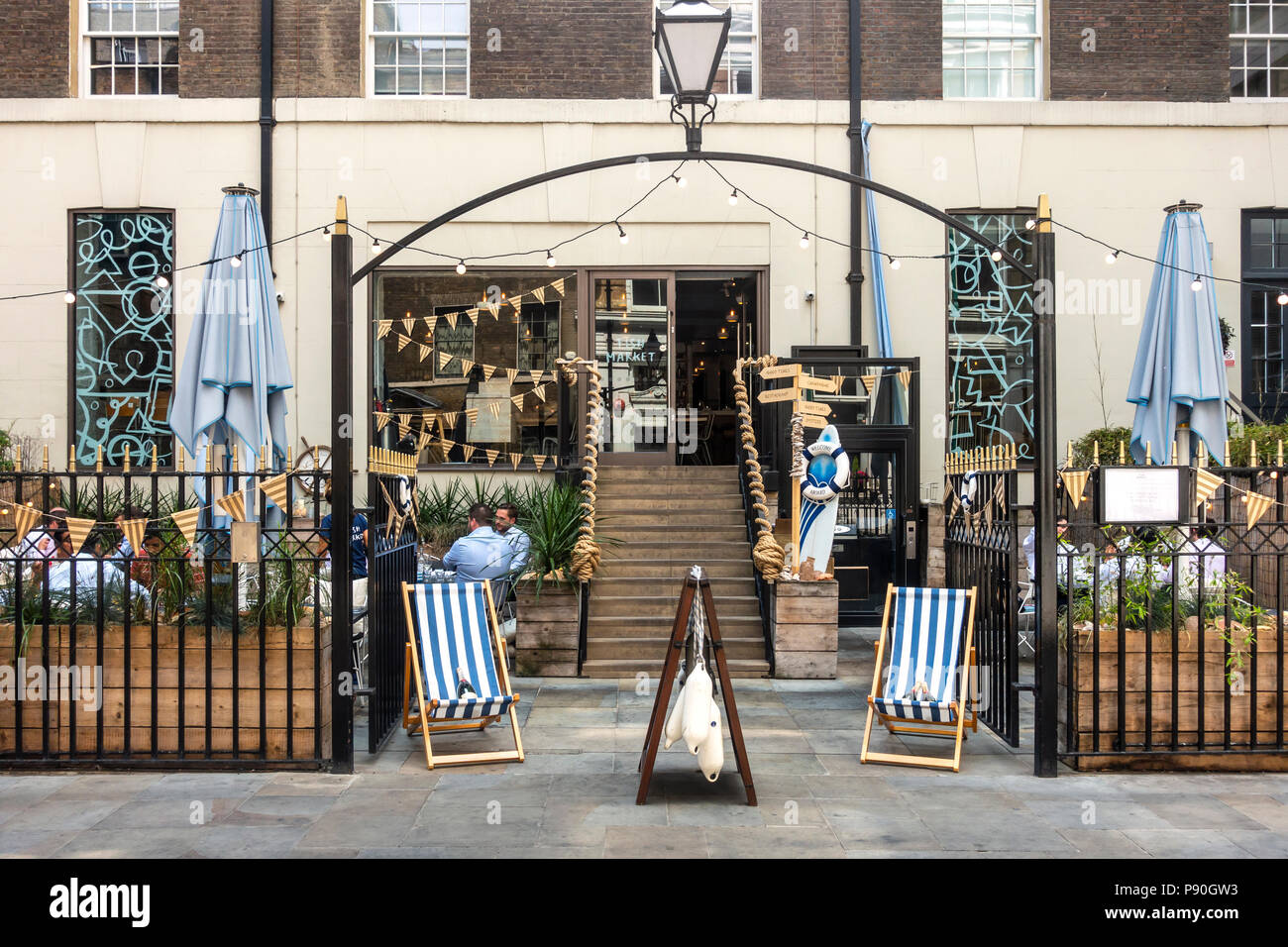 Customers in the outdoor seated area of the seaside-themed Fish Market ...