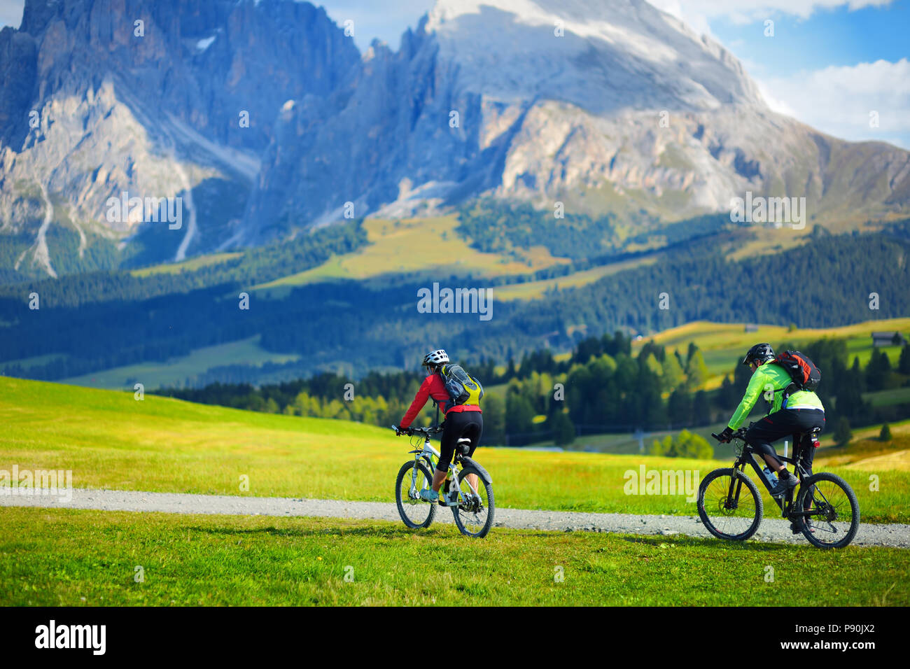 Tourists cycling in Seiser Alm, the largest high altitude Alpine meadow ...