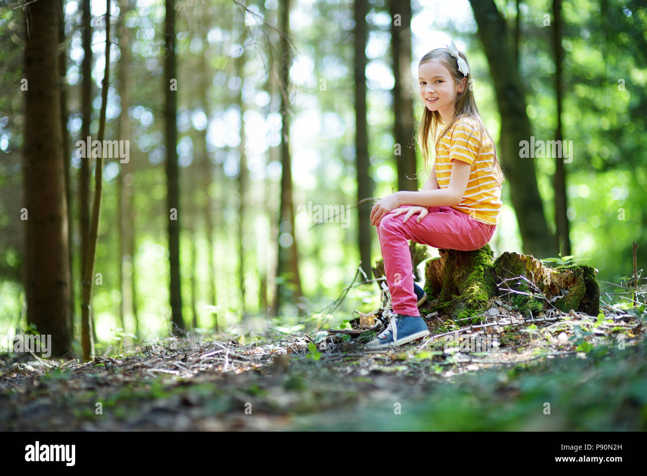 Cute little girl having fun during forest hike on beautiful summer day ...