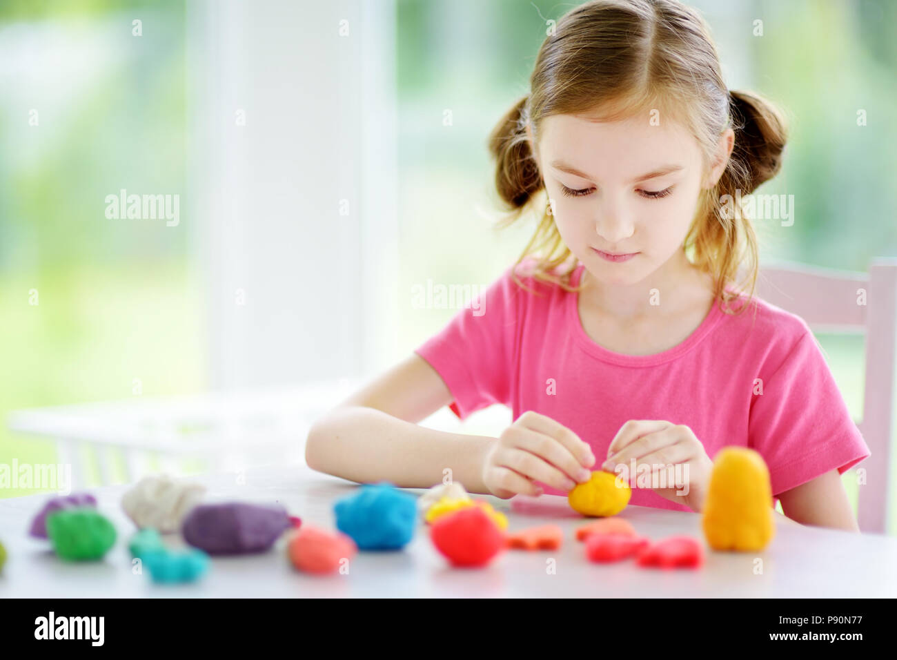 Girl playing modeling clay hi-res stock photography and images - Alamy