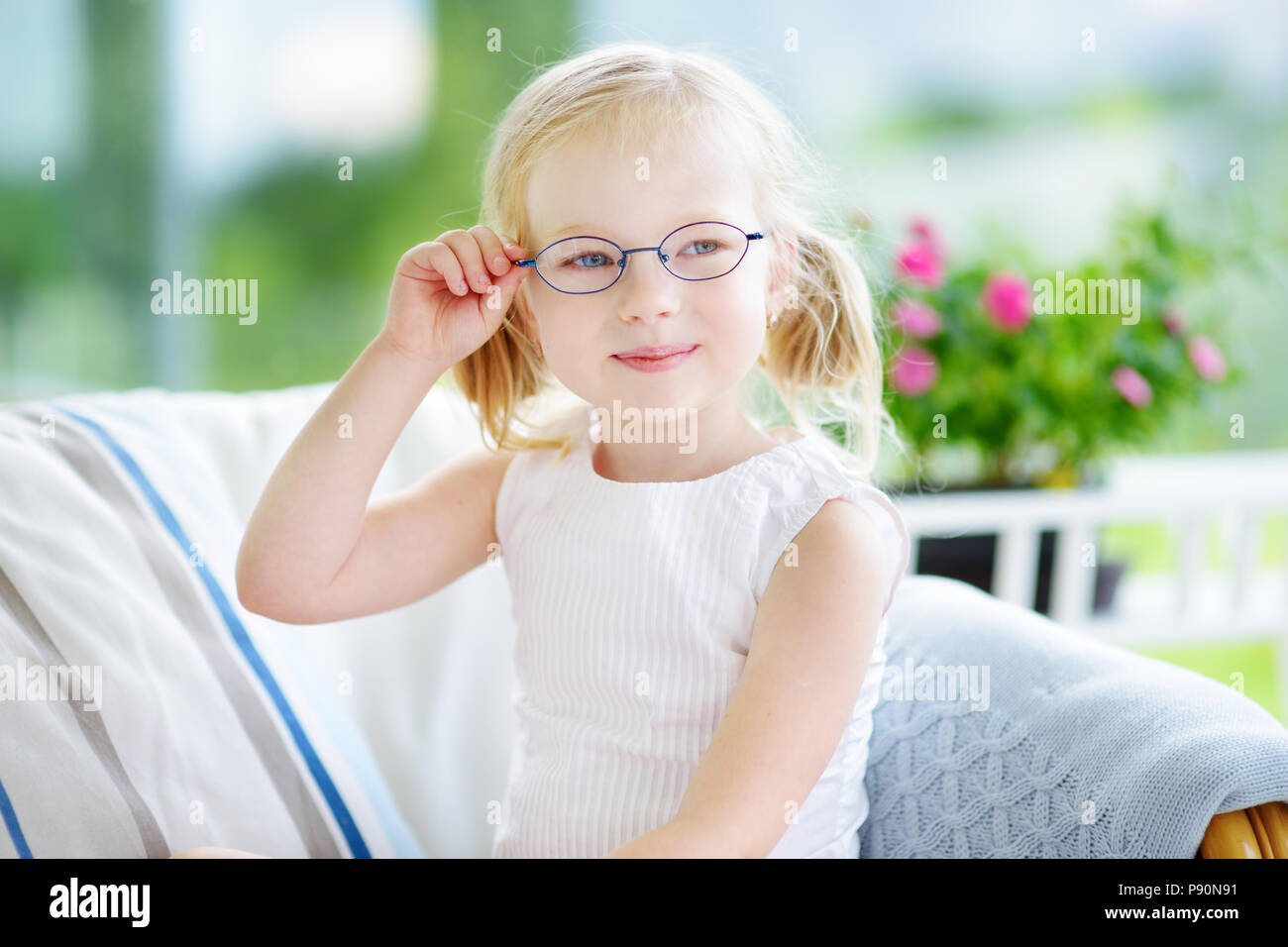 Portrait of beautiful little girl wearing glasses at home. Vision ...