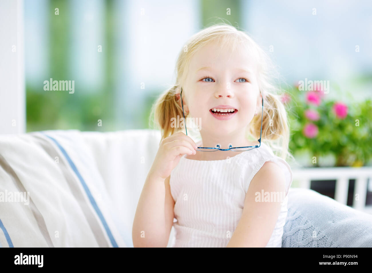Portrait of beautiful little girl wearing glasses at home. Vision ...